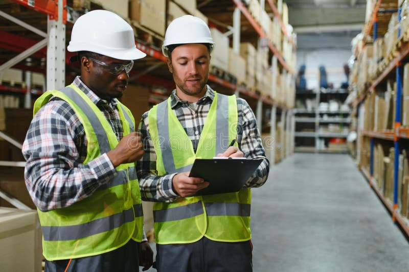 Two Warehouse Workers Checking and Controlling Boxes in Warehouse ...