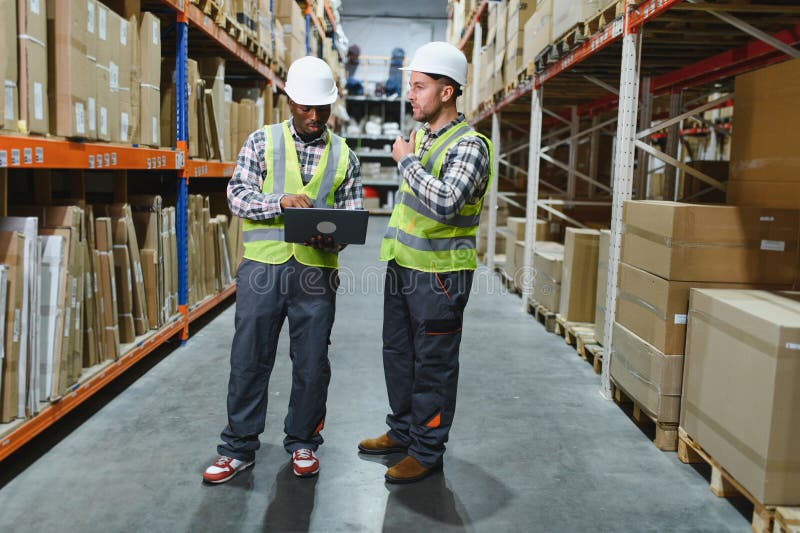 Two Warehouse Workers Checking and Controlling Boxes in Warehouse ...