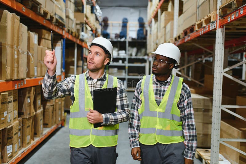 Two Warehouse Workers Checking and Controlling Boxes in Warehouse ...