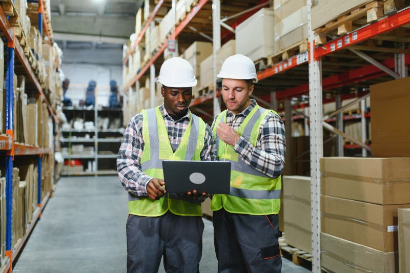 Two Warehouse Workers Checking and Controlling Boxes in Warehouse ...