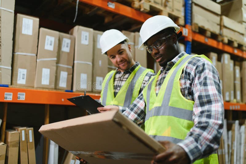 Two Warehouse Workers Checking and Controlling Boxes in Warehouse ...