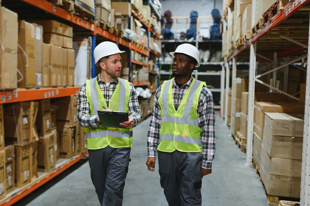 Two Warehouse Workers Checking and Controlling Boxes in Warehouse ...