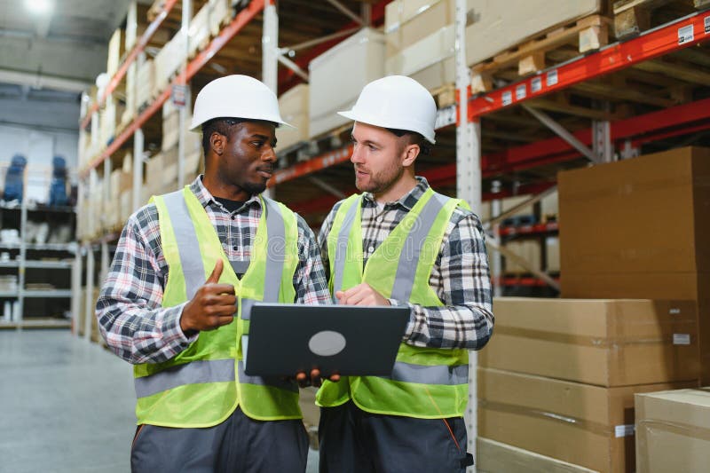 Two Warehouse Workers Checking and Controlling Boxes in Warehouse ...