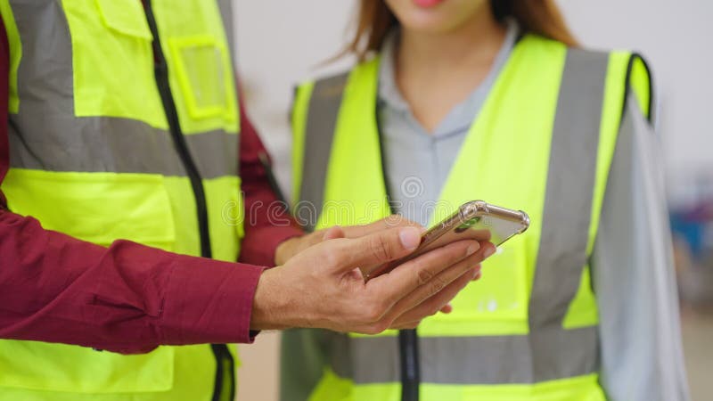 Two Warehouse Workers with Safety Helmet Working Together at Factory ...