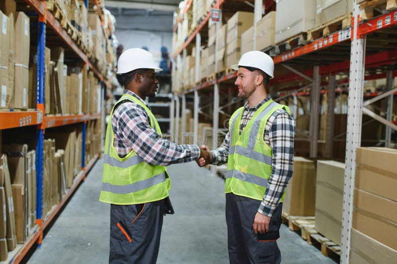 Two Warehouse Workers Shaking Hand when Success Project or First Time ...