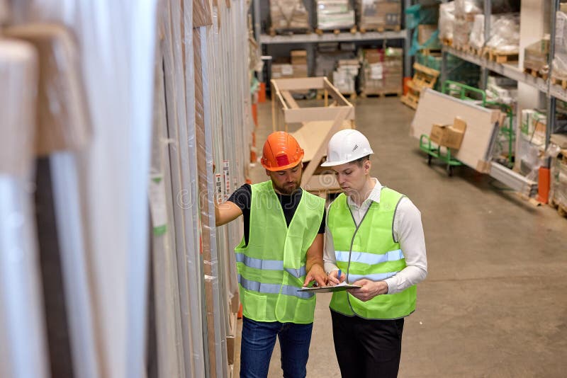 Two Warehouse Managers in Work Wear Organizing Distribution in ...