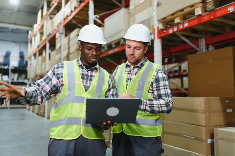 Two Warehouse Workers are Walking through the Facility, Engaged in ...
