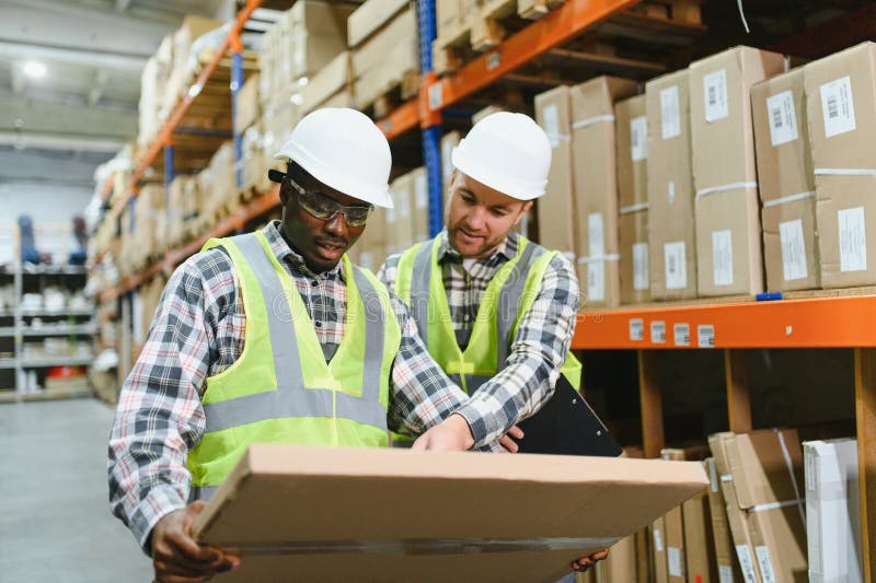 Two Warehouse Workers are Walking through the Facility, Engaged in ...