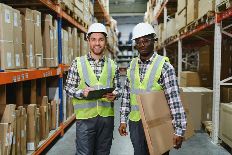 Two Warehouse Workers are Walking through the Facility, Engaged in ...