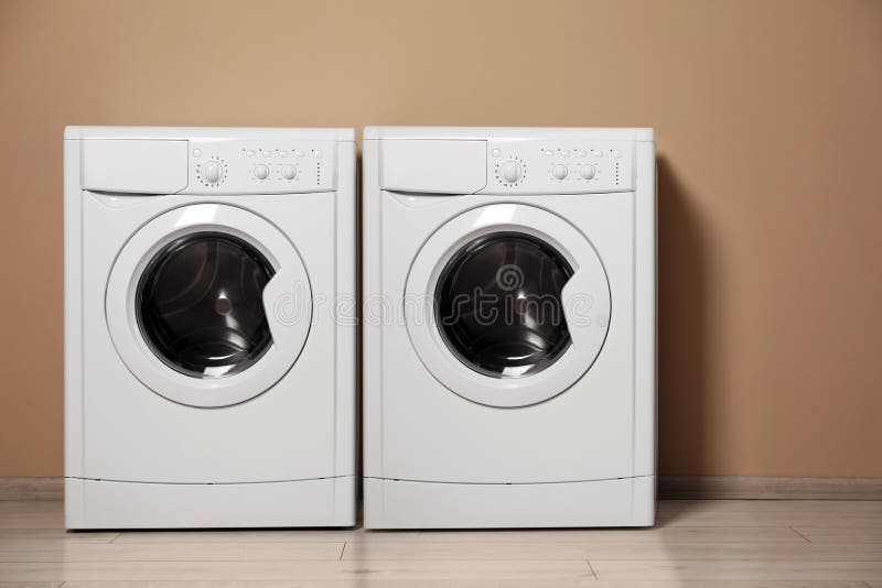 Two Washing Machines Near Dark Beige Wall Stock Photo - Image of clean ...