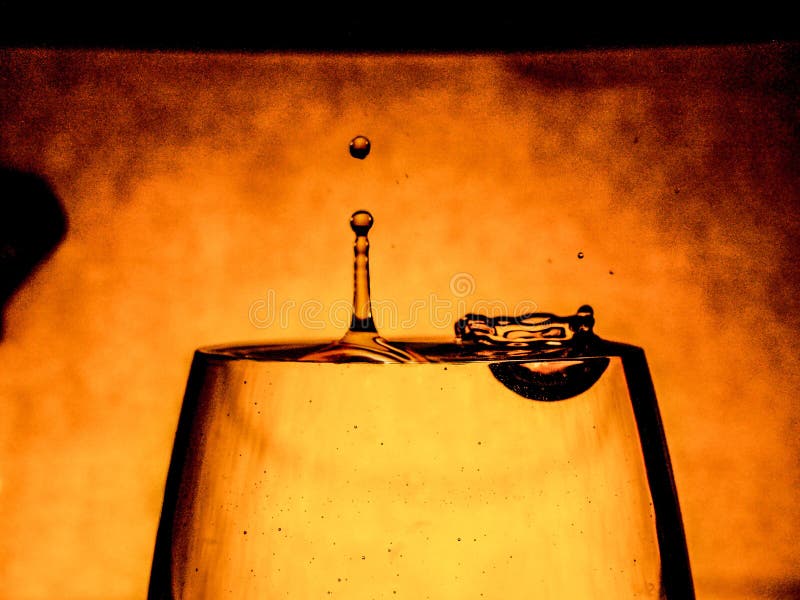 A Droplet Falls into a Glass of Water Stock Photo - Image of ripples ...