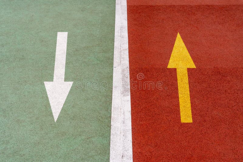 A Two Way Arrows Pointing in Opposite Directions Symbol on a Road ...