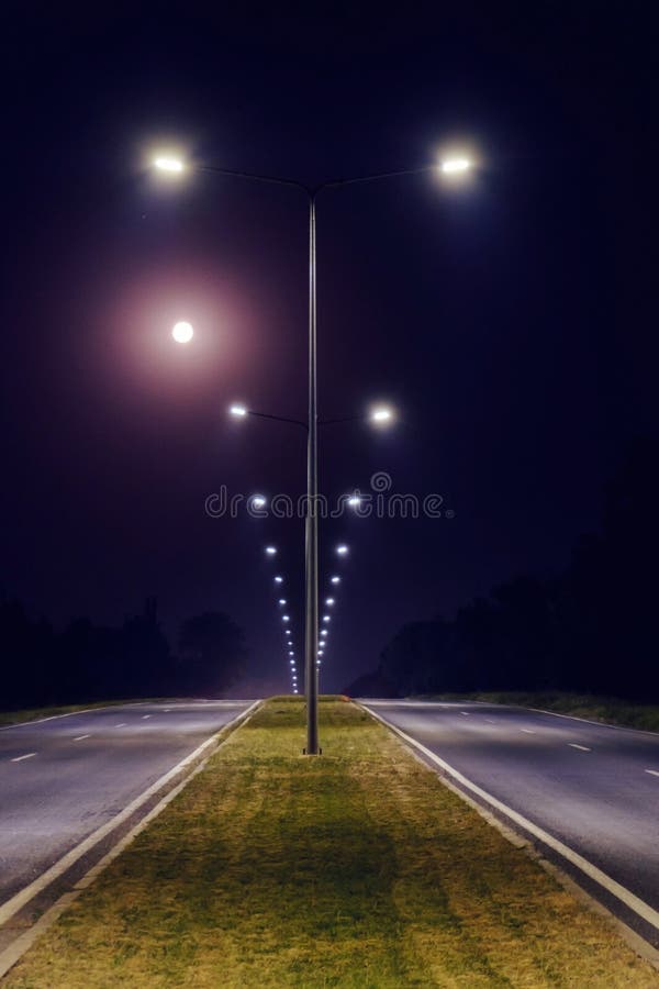 A Two-way Road is Illuminated by the Light Post Stock Photo - Image of ...