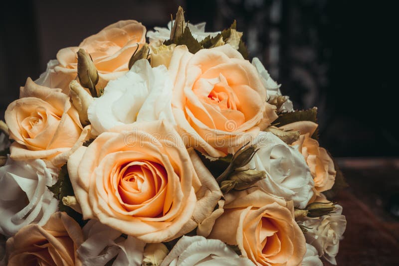 Two Wedding Rings and a Bouquet of Orange and White Roses. Stock Image ...