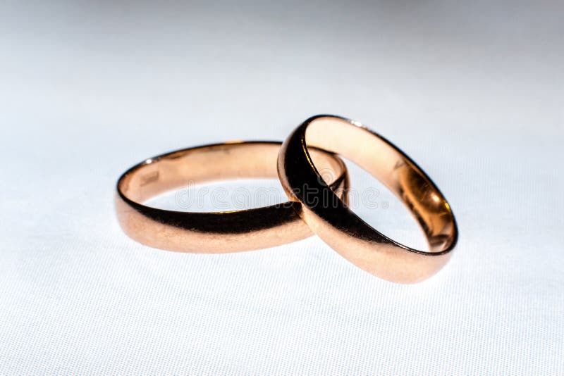 Two Wedding Rings of Different Sizes Made in Gold on the White Light ...