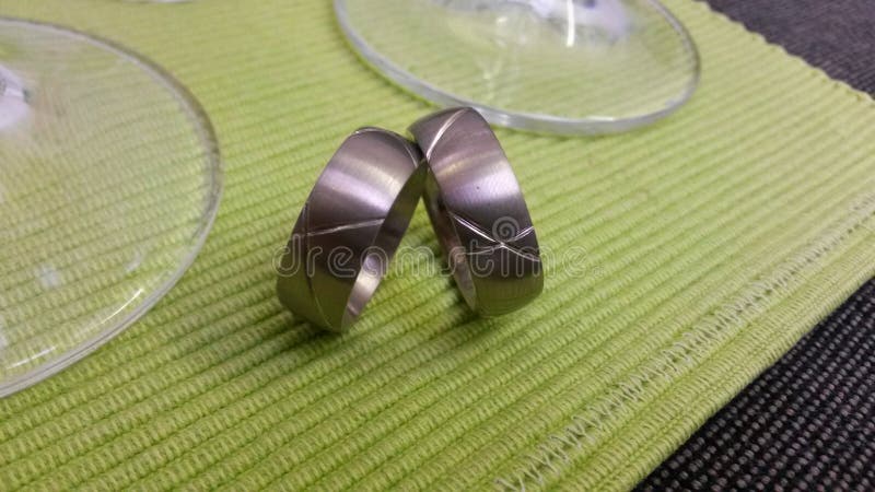 Two Wedding Rings in Front of Two Champagne Flutes Stock Image - Image ...