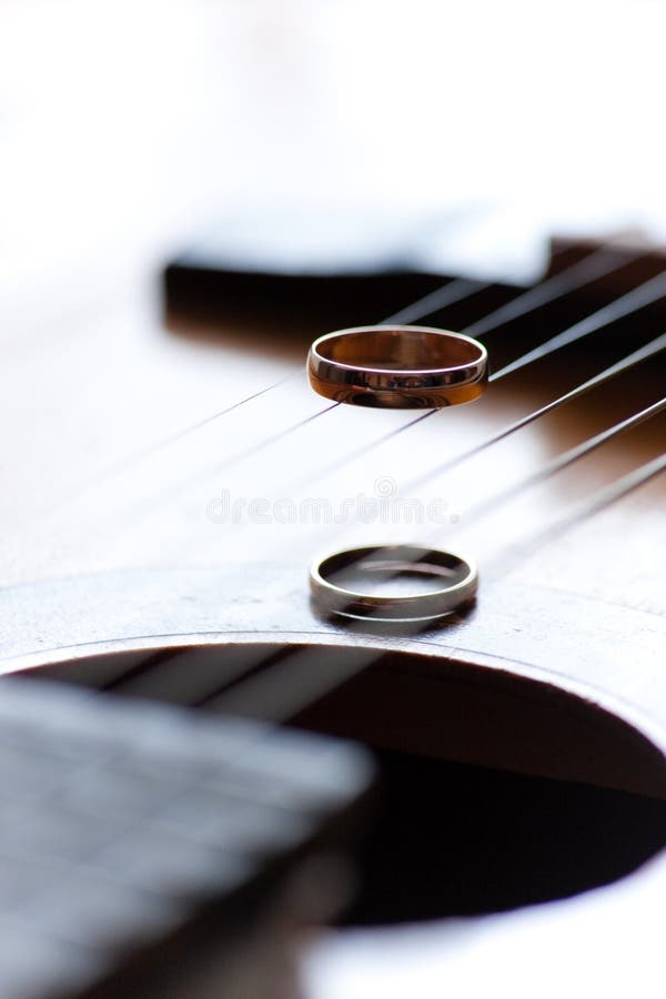 Two Wedding Rings are on Guitar Stripes Stock Photo - Image of mirror ...