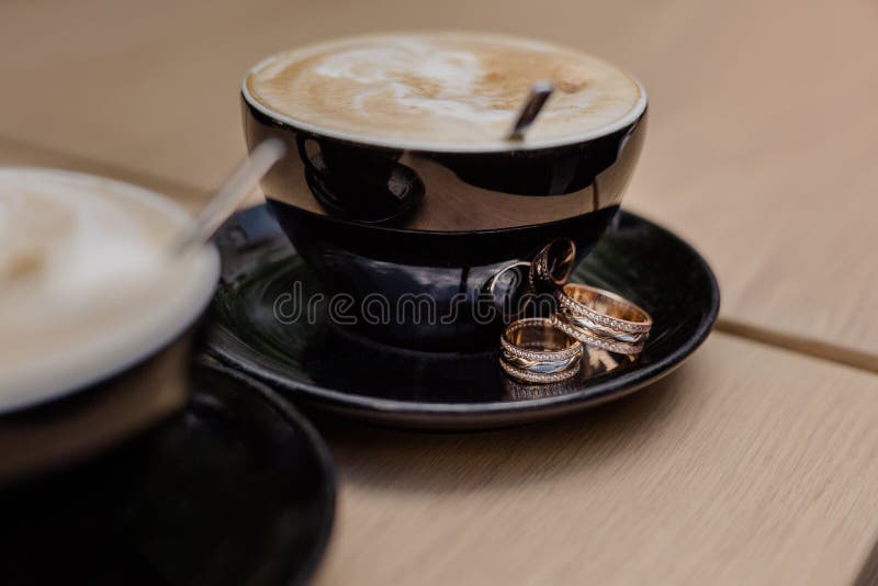 Two Wedding Rings on Saucer with a Cup of Coffee on Table. Stock Image - Image of decoration ...