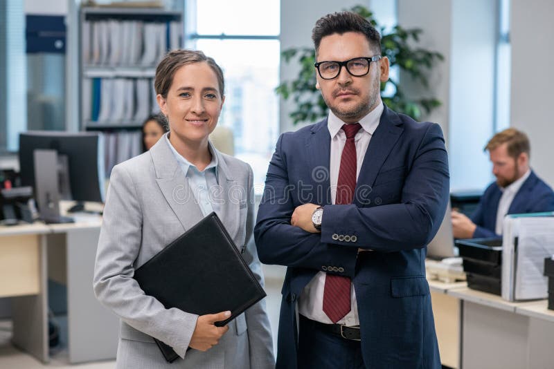 Two Well-dressed Employees Standing in Front of Camera Stock Photo ...