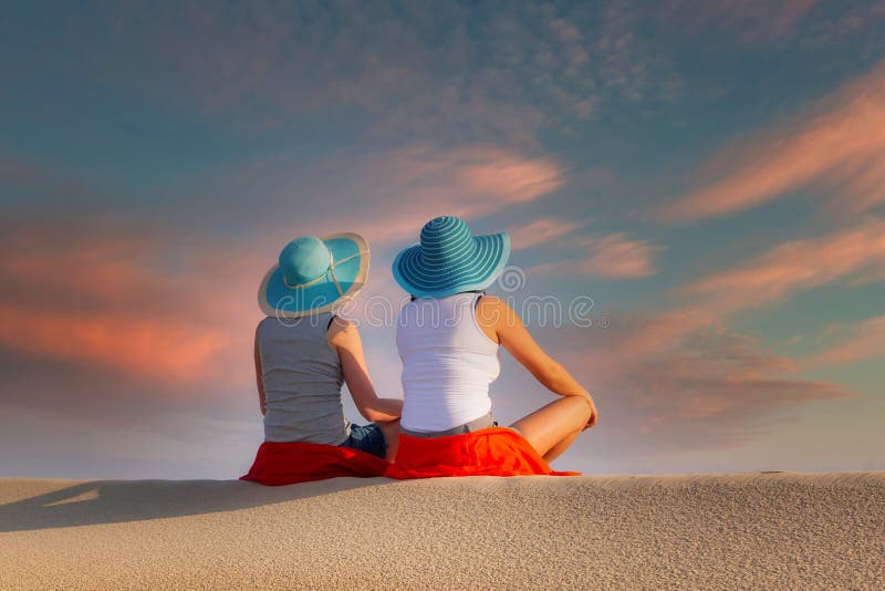 Two Wemen on Vacations at the Sandy Desert at Sunset, UAE Stock Photo ...