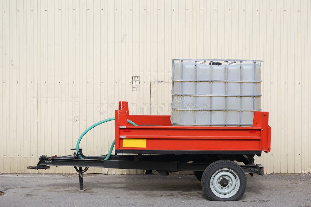Two-wheeled Red Trailer with Plastic Water Container Stock Image ...