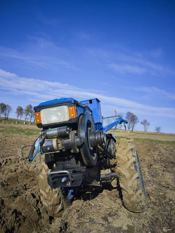 Two-wheeled Tractor in the Field,against the Background of the Blue Sky ...
