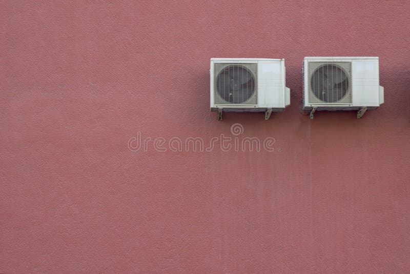 Two White Air Conditioner Radiators on a Red Granular Concrete Wall ...
