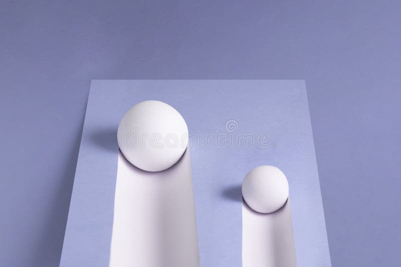 Two White Balls Roll Downhill and Leave a Trail on a Purple Background ...