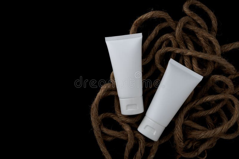 Two White Cream Tube on Pile of Ropes. for Mockup Stock Photo - Image ...