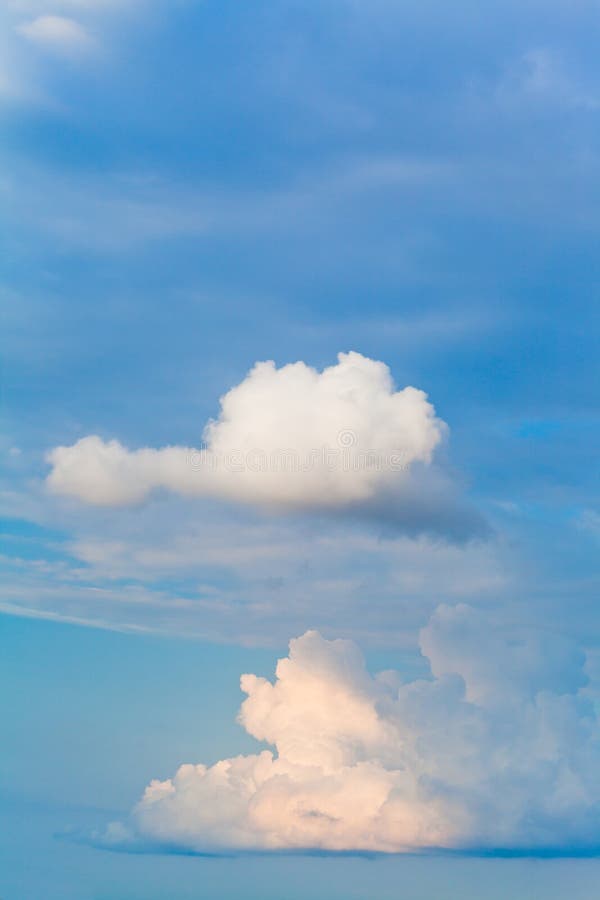 Two white cumulus clouds stock image. Image of landscape - 26316029