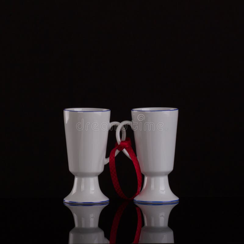 Two White Cups on the Associated with a Red Ribbon. Stock Photo - Image ...