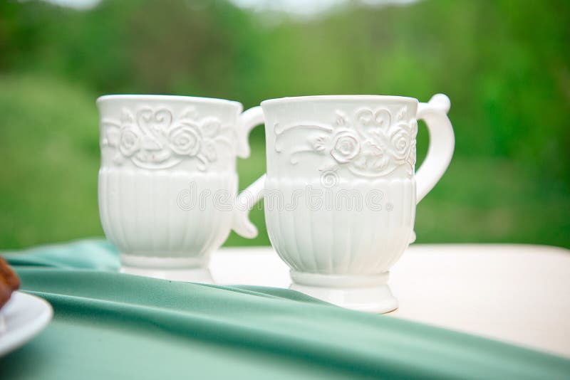Two White Empty Cups on Table Against Green Background. Stock Image ...