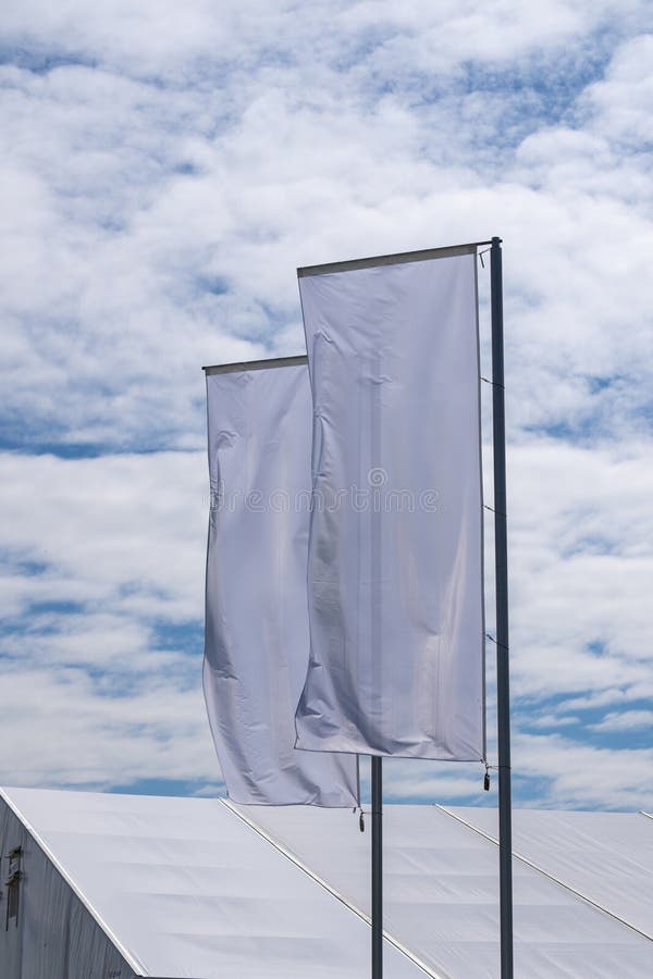 Two White Flags are on Poles in the Sky Stock Image - Image of ...