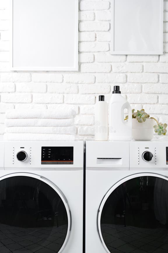 Two White Front Loading Washing Machines in Modern Laundry Room Stock ...