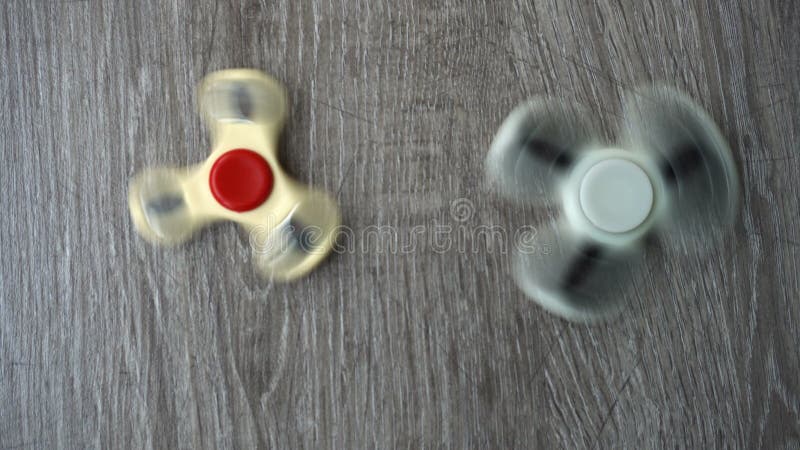 Two White Hand Spinner Spinning on Grey Background or Fidget Spinners ...