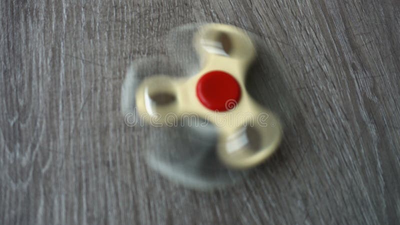 Two White Hand Spinner Spinning on Grey Background or Fidget Spinners ...
