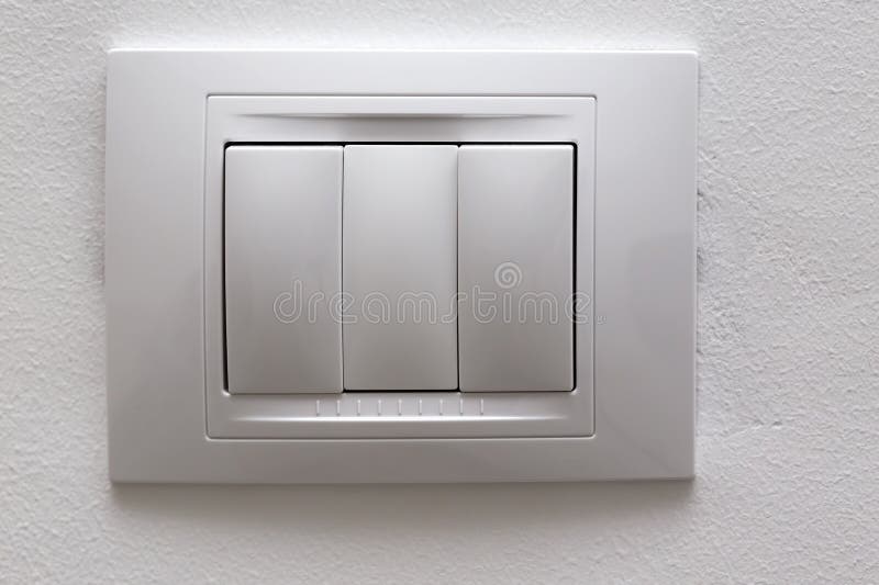 Two White Lighting Switchs on Concrete Wall Separated by on False Cap ...