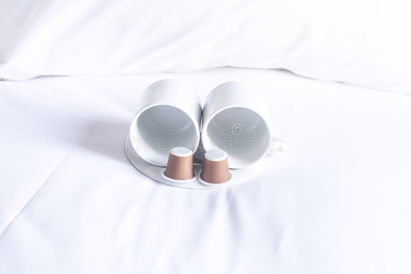 Two White Mugs with Coffee Capsules. Breakfast Bed Stock Photo - Image ...