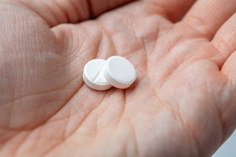 Two pills on a hand stock photo. Image of closeup, pills - 116083996
