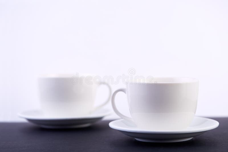 Two White Porcelain Teacups on Black Table Show Clean and Simple Design ...