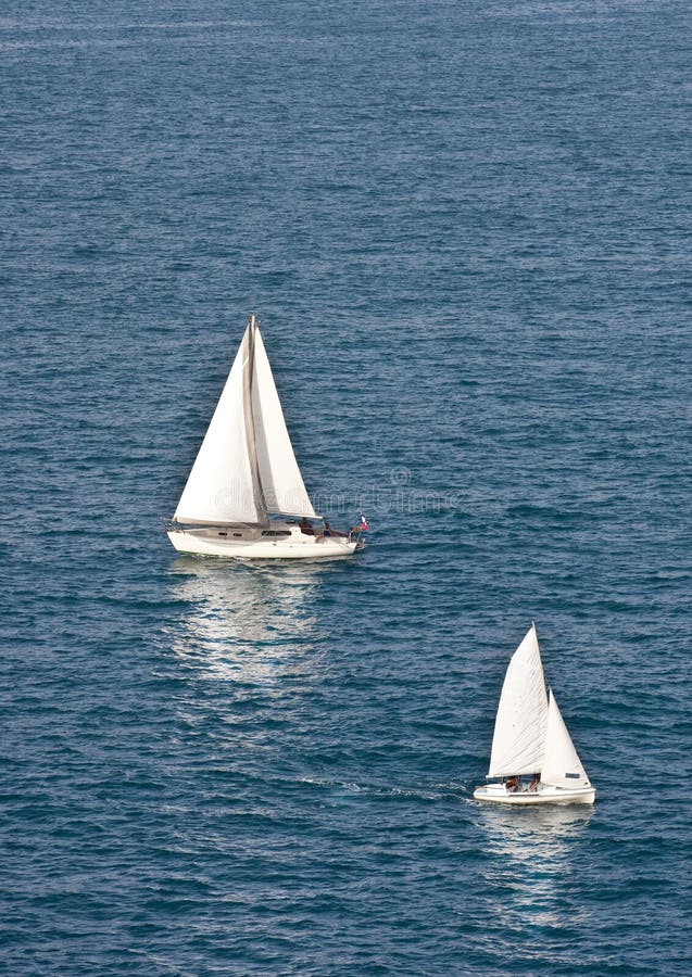 Two White Sails on Blue Water Stock Image - Image of boat, sails: 11052153