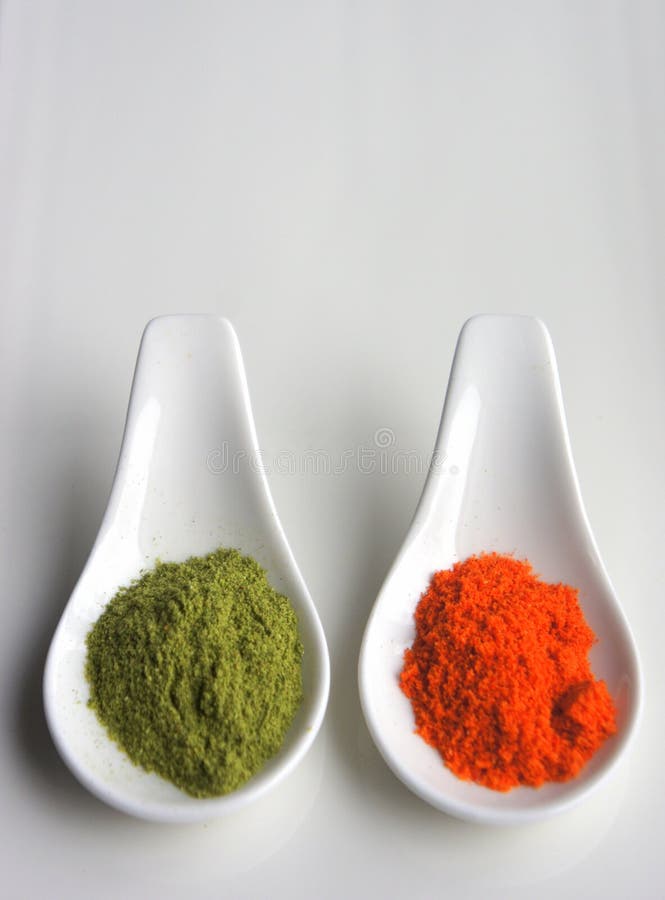 Two White Serving Spoons Filled with Condiments Stock Image - Image of ...