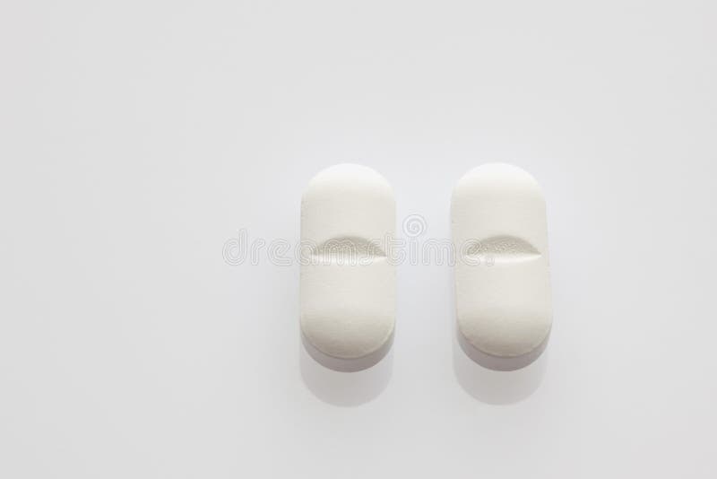 Two white tablets stock photo. Image of antibiotics, medicine - 50475808