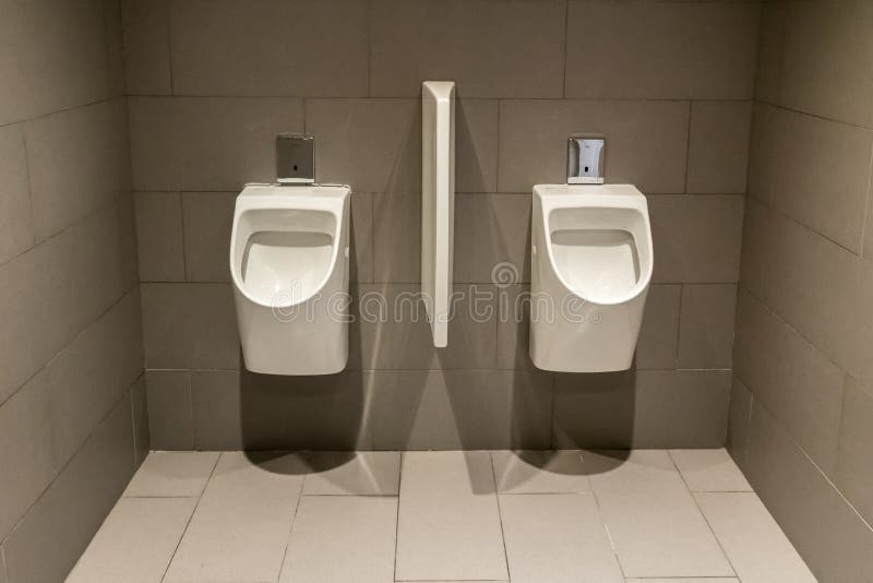 Two White Urinals in the Men`s Room in a Modern Office Building. Stock ...