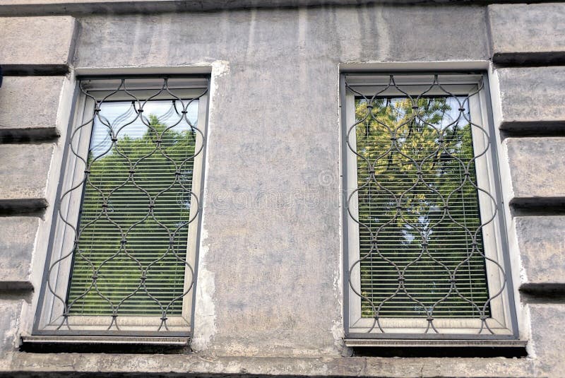 Two White Windows with a Iron Lattice on a Gray Concrete Wall Stock ...