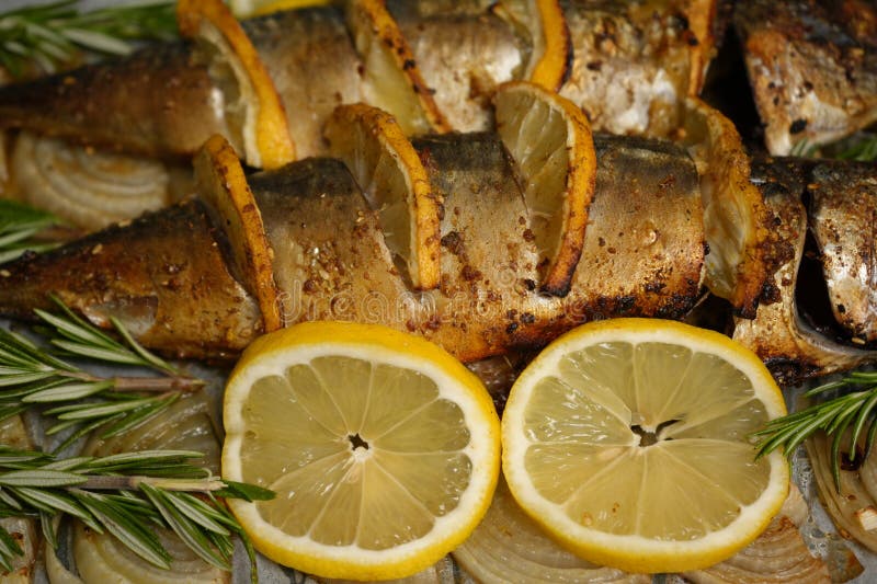 Two Whole Baked Fish with Lemon and Rosemary Close-up. Stock Image ...
