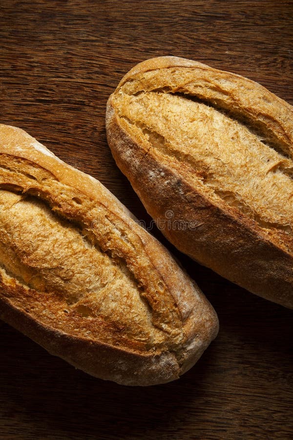 Two Whole Grain Breads on Wooden Table. Close View. Stock Photo - Image ...
