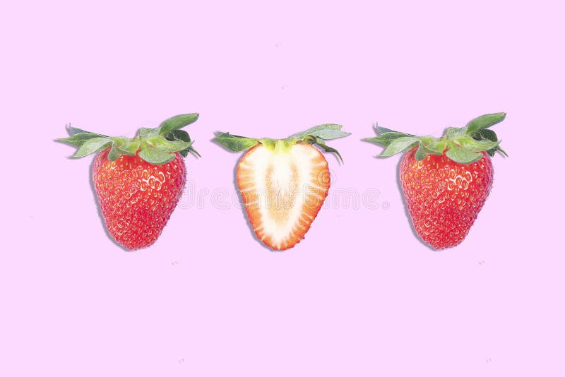 Two Whole and One Cut in Half Strawberries with Green Leaves on Pink ...