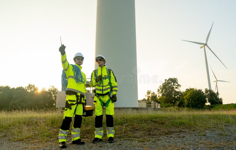 Two of Wind Turbine or Windmill Workers or Technician Stand on Base of ...