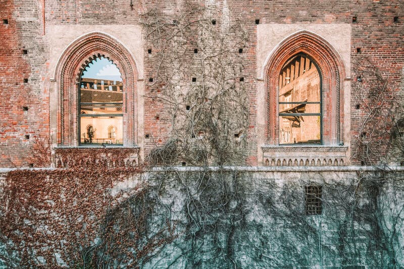 Two Windows on a Building with a Reflection of a Person in the Left ...